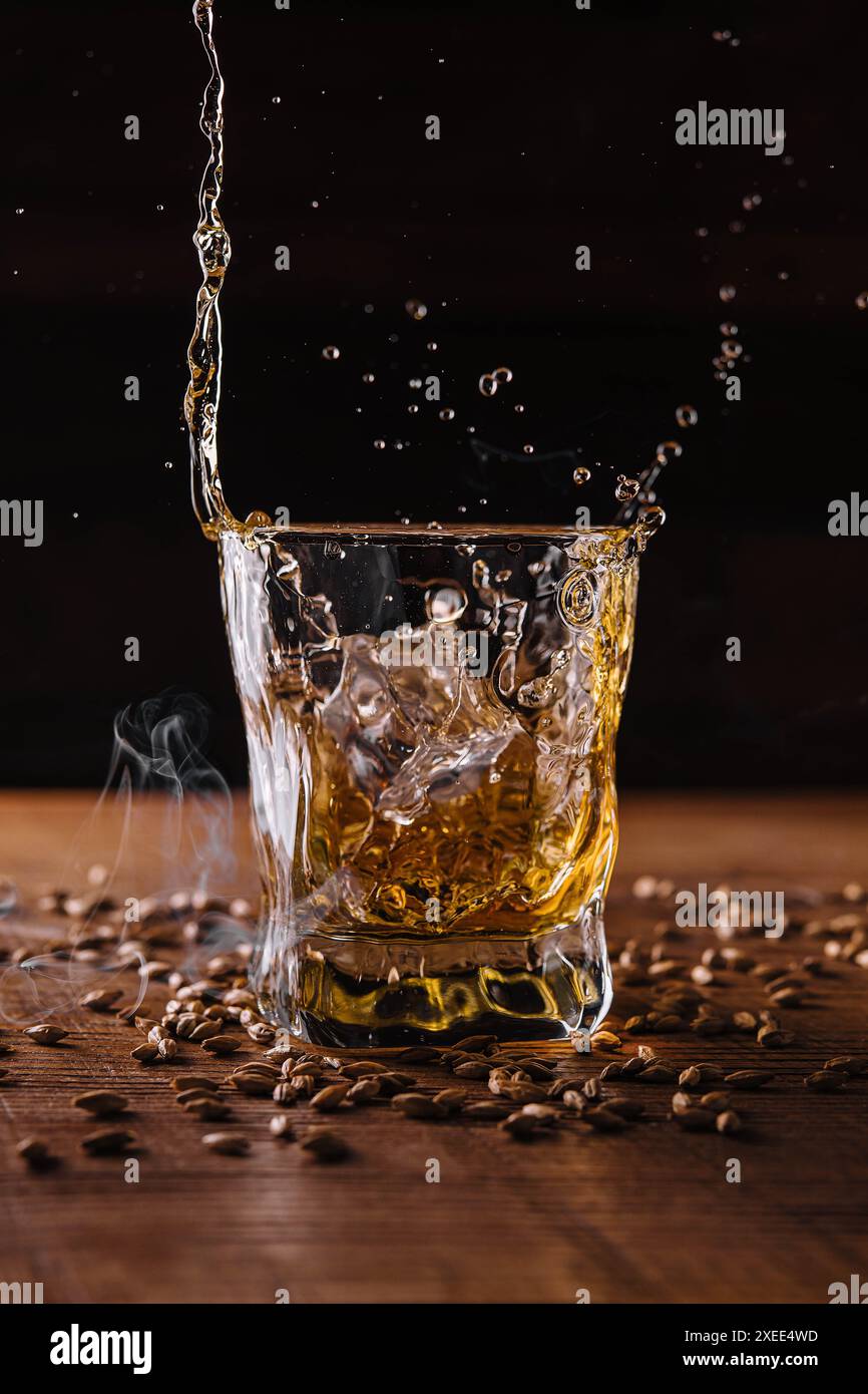 Pouring whiskey cognac glass ice hi-res stock photography and images - Alamy