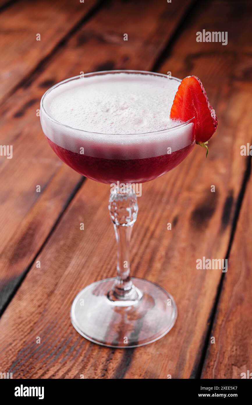 Strawberry alcoholic cocktail with foam on wood Stock Photo - Alamy