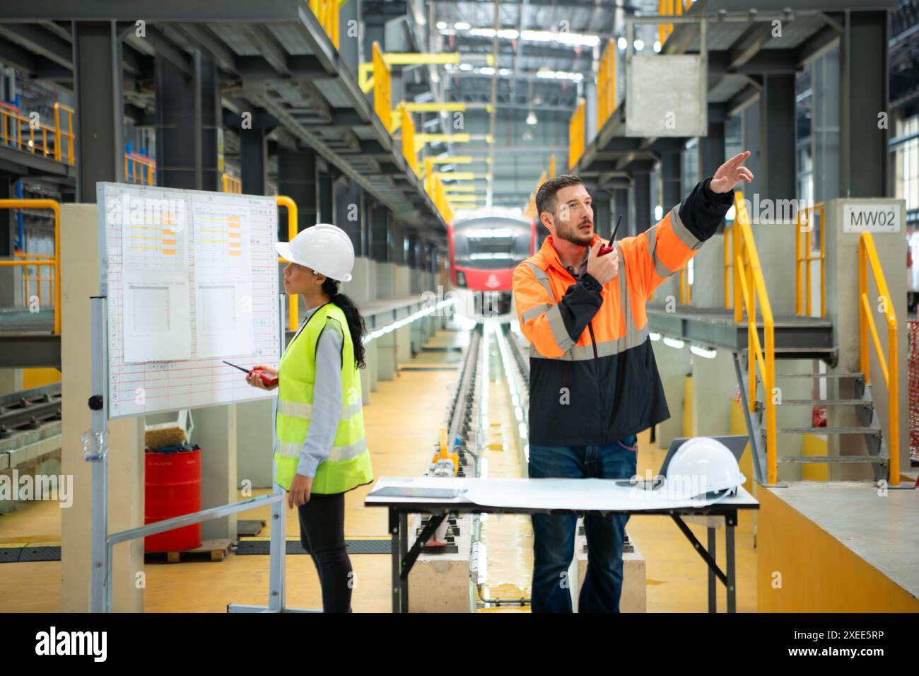Male and female engineers work together in an electric repair station ...