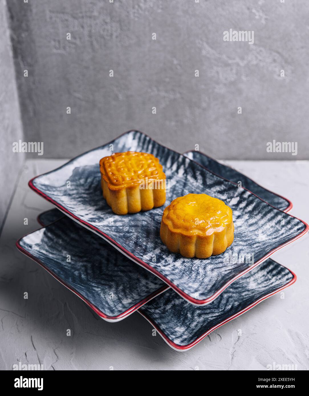 two chinese cakes on traditional plates Stock Photo - Alamy