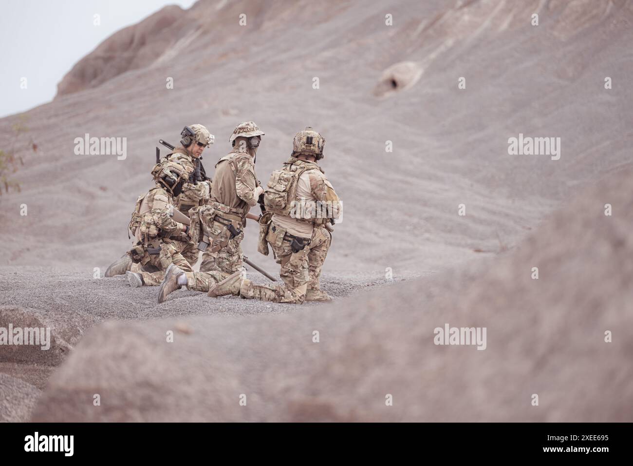 Soldiers in camouflage military uniforms carrying weapons, Reconnaissance missions in rugged ...