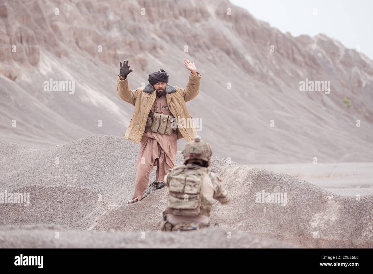 A Taliban soldier stands with a machine gun, Raise hands in surrender ...