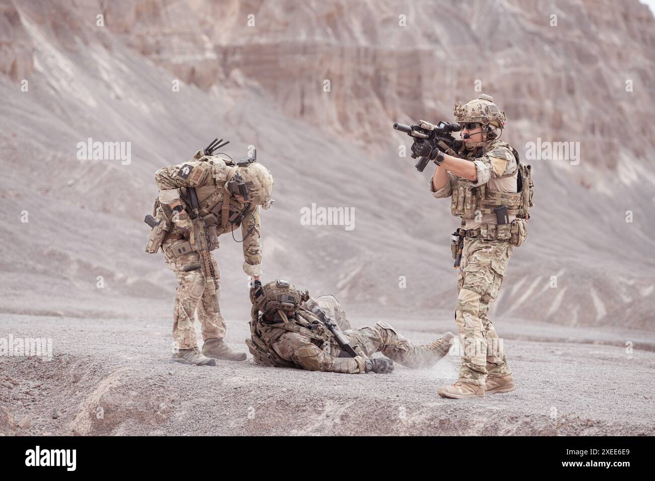 Soldiers in camouflage military uniforms carrying weapons ...