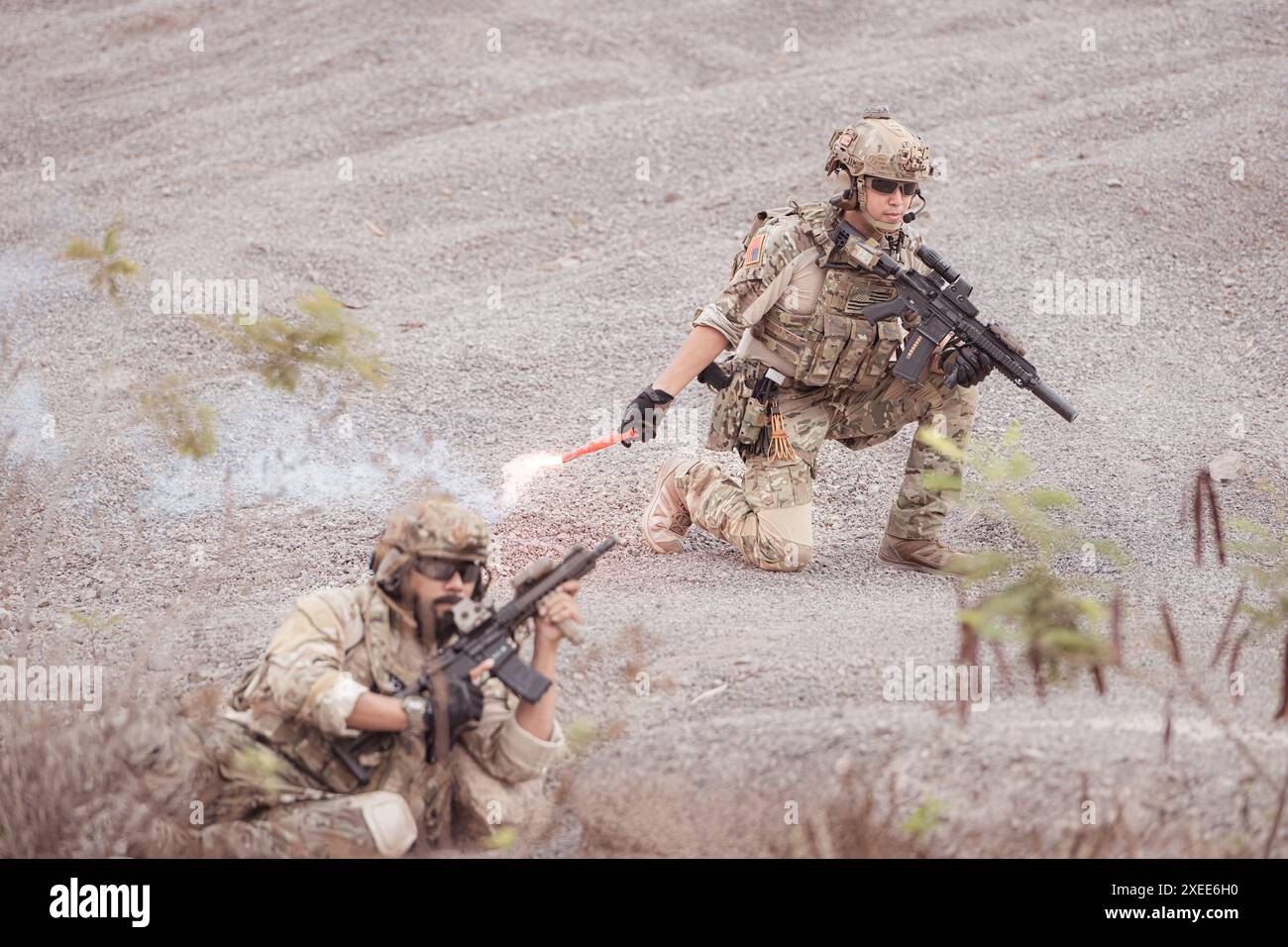 Soldiers in camouflage military uniforms carrying weapons ...