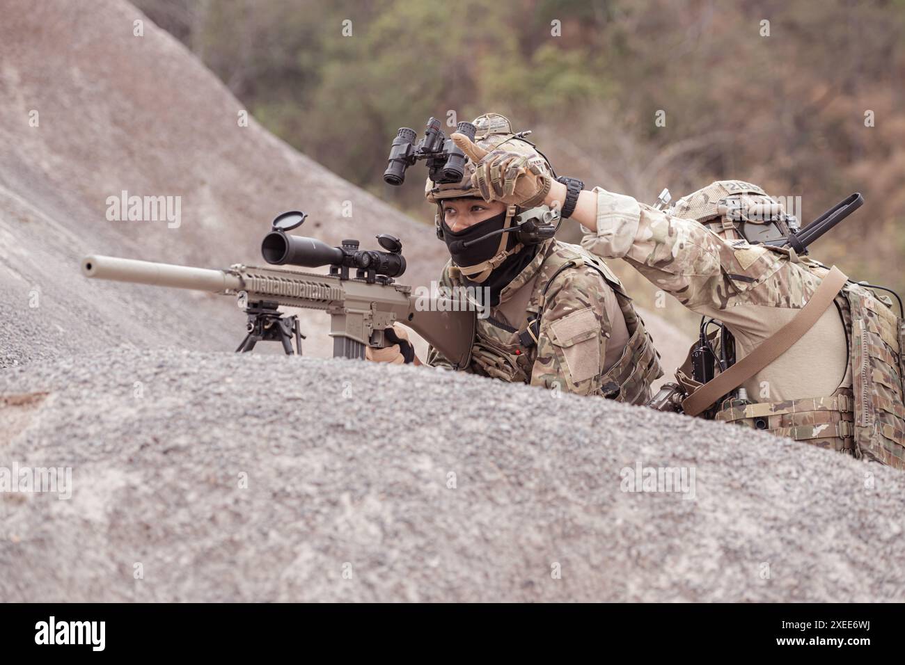 Soldiers in camouflage military uniforms carrying weapons ...