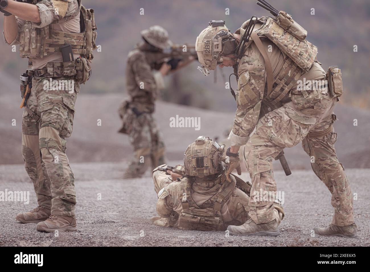 Soldiers in camouflage military uniforms carrying weapons ...