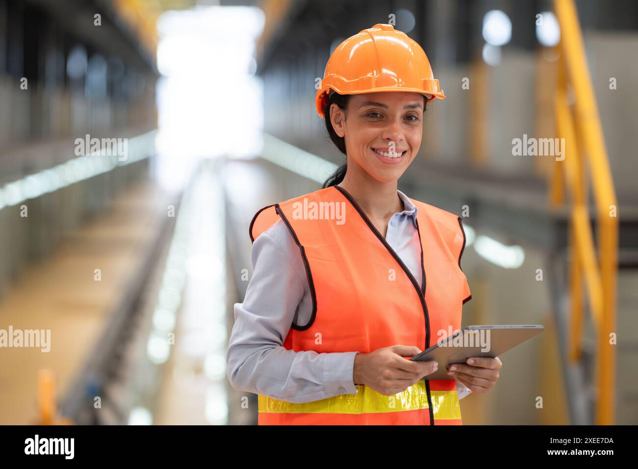 Portrait of a young female engineer standing in the skytrain repair ...