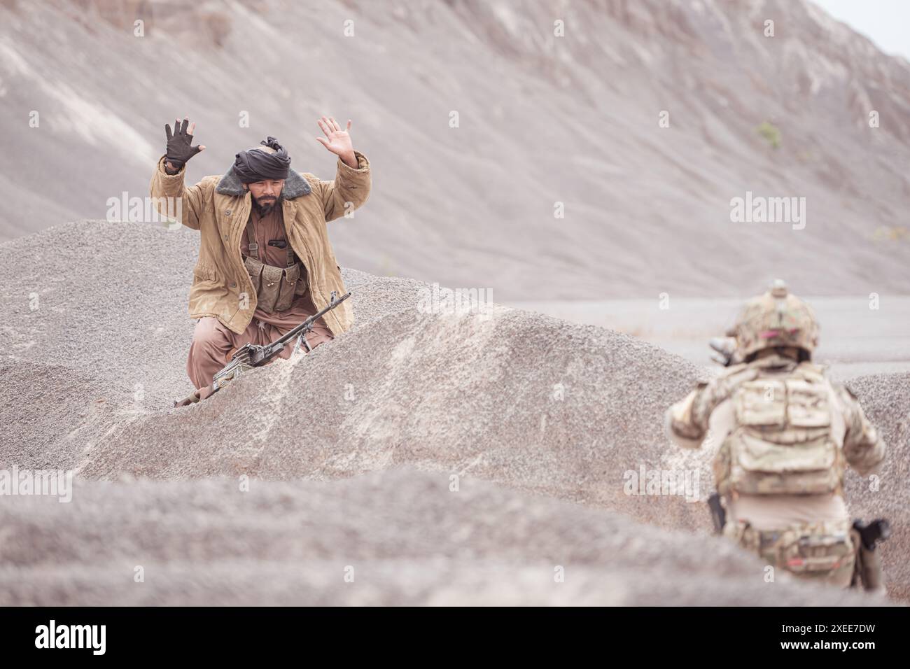 A Taliban soldier stands with a machine gun, Raise hands in surrender ...