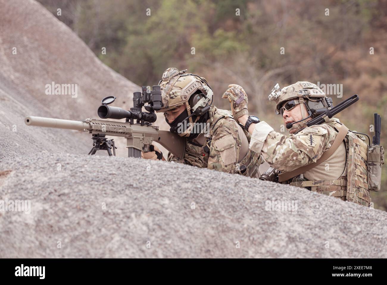 Soldiers in camouflage military uniforms carrying weapons ...