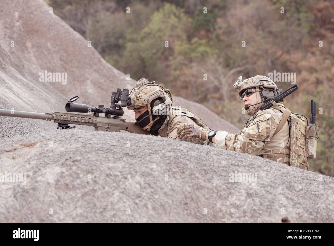 Soldiers in camouflage military uniforms carrying weapons ...