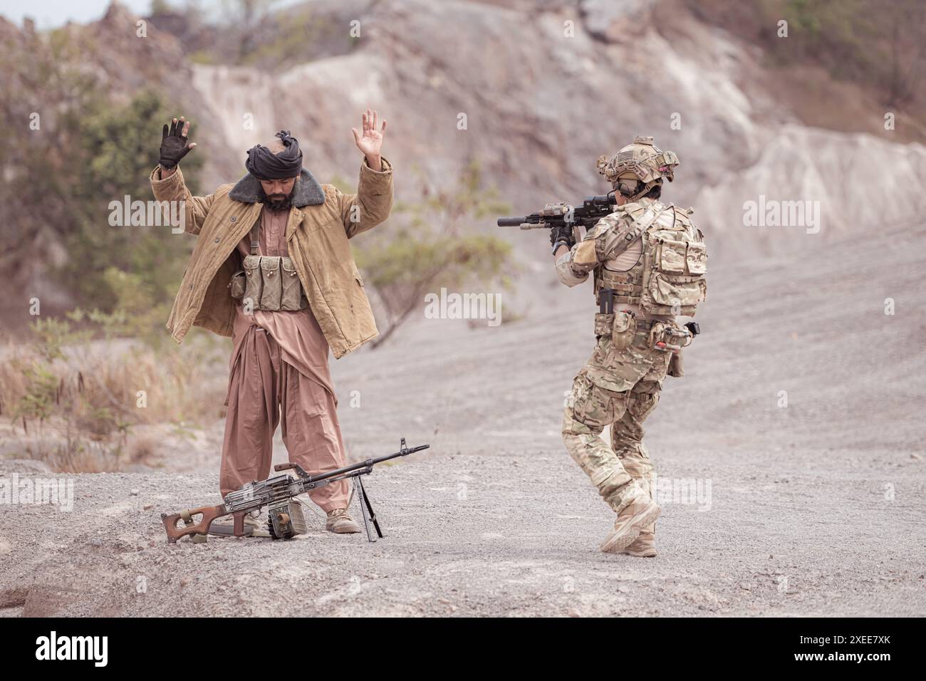 A Taliban soldier stands with a machine gun, Raise hands in surrender ...