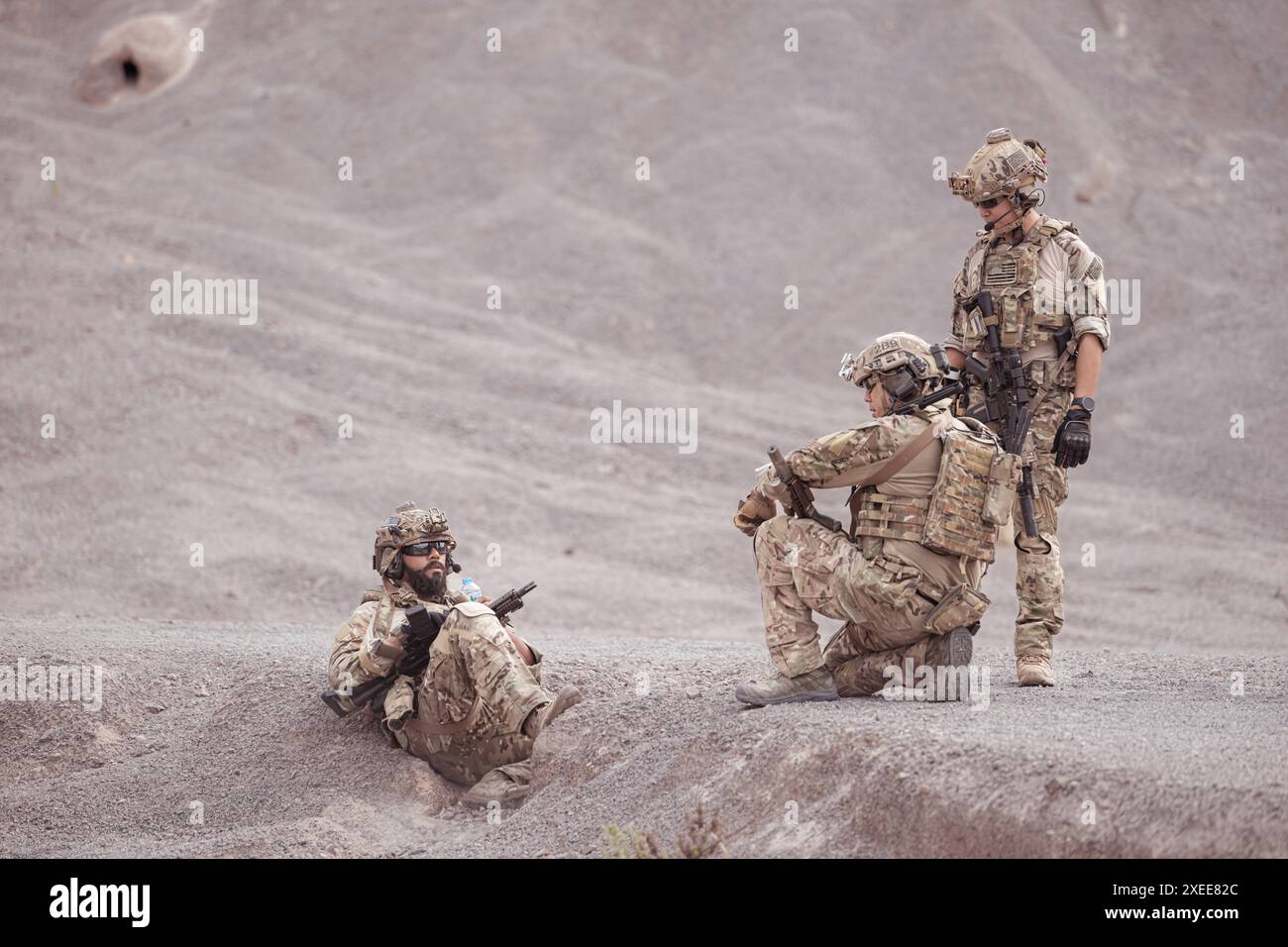 Soldiers in camouflage military uniforms carrying weapons ...