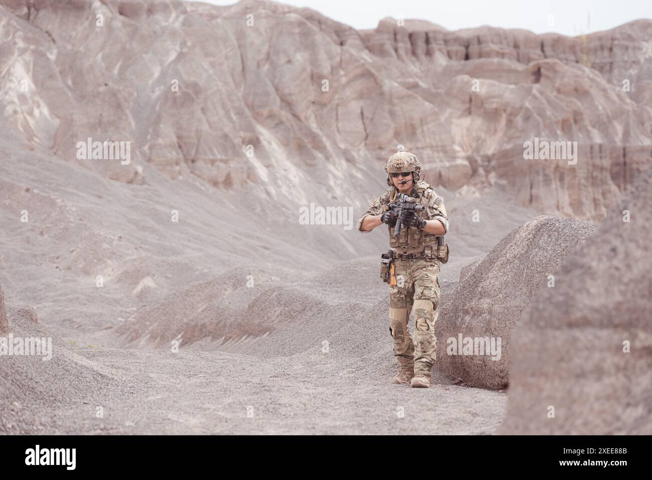 Soldiers in camouflage military uniforms carrying weapons ...
