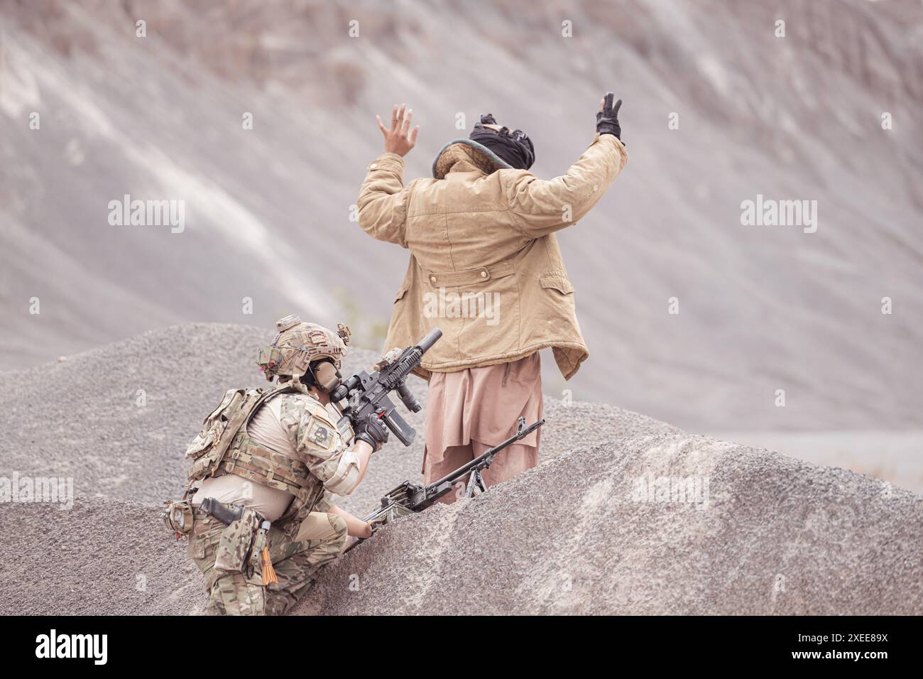 A Taliban soldier stands with a machine gun, Raise hands in surrender ...