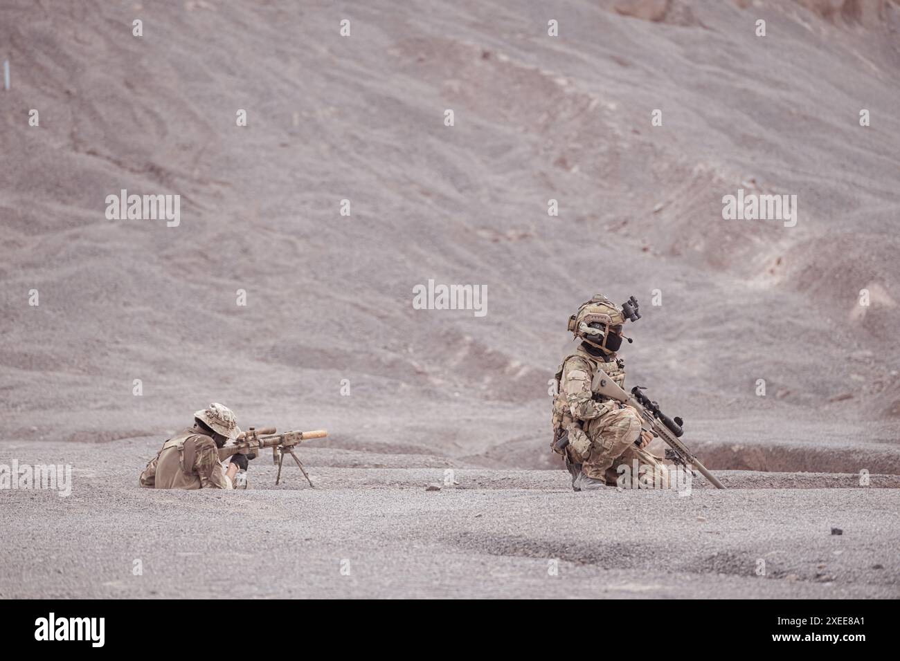 Soldiers in camouflage military uniforms carrying weapons ...