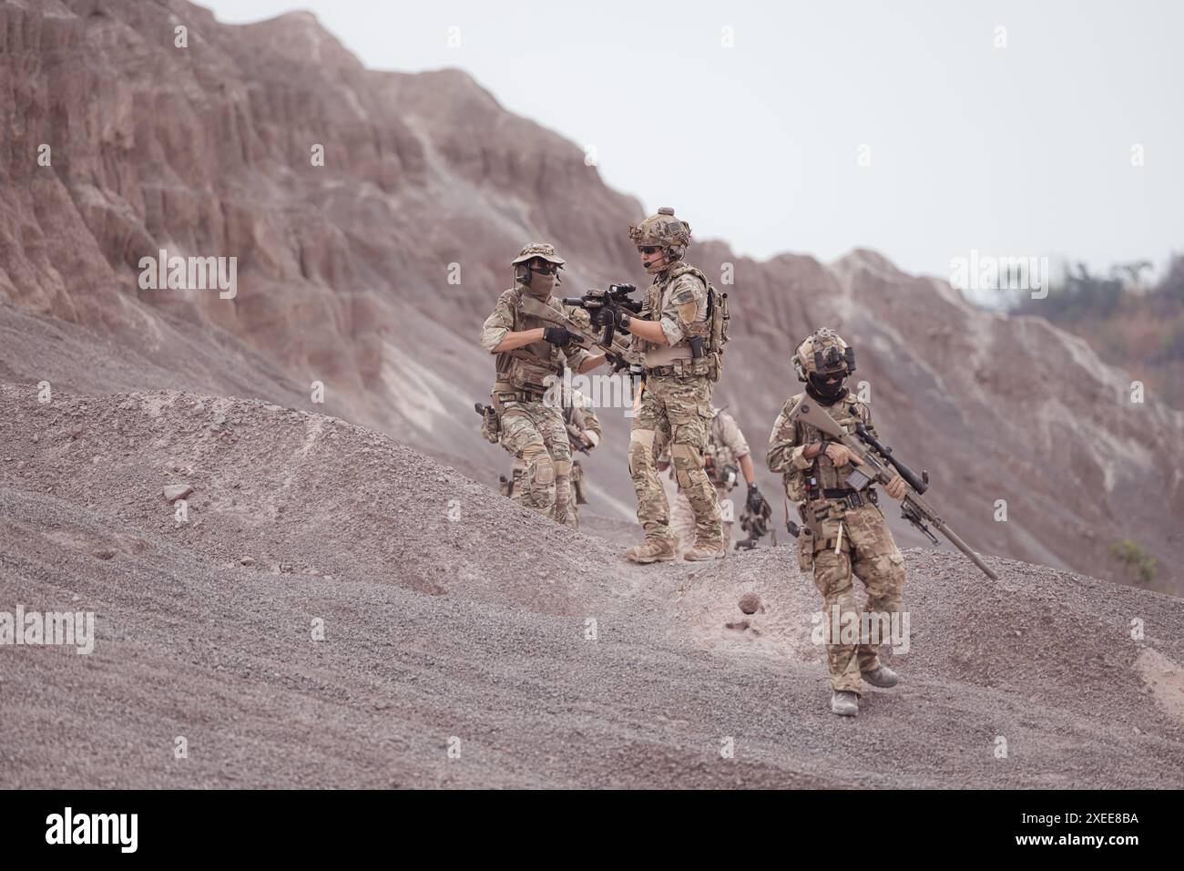 Soldiers in camouflage military uniforms carrying weapons ...