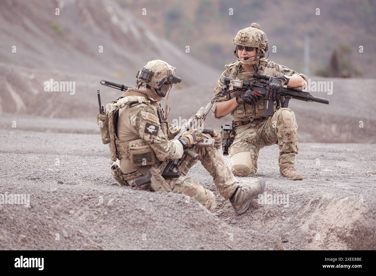Soldiers in camouflage military uniforms carrying weapons ...