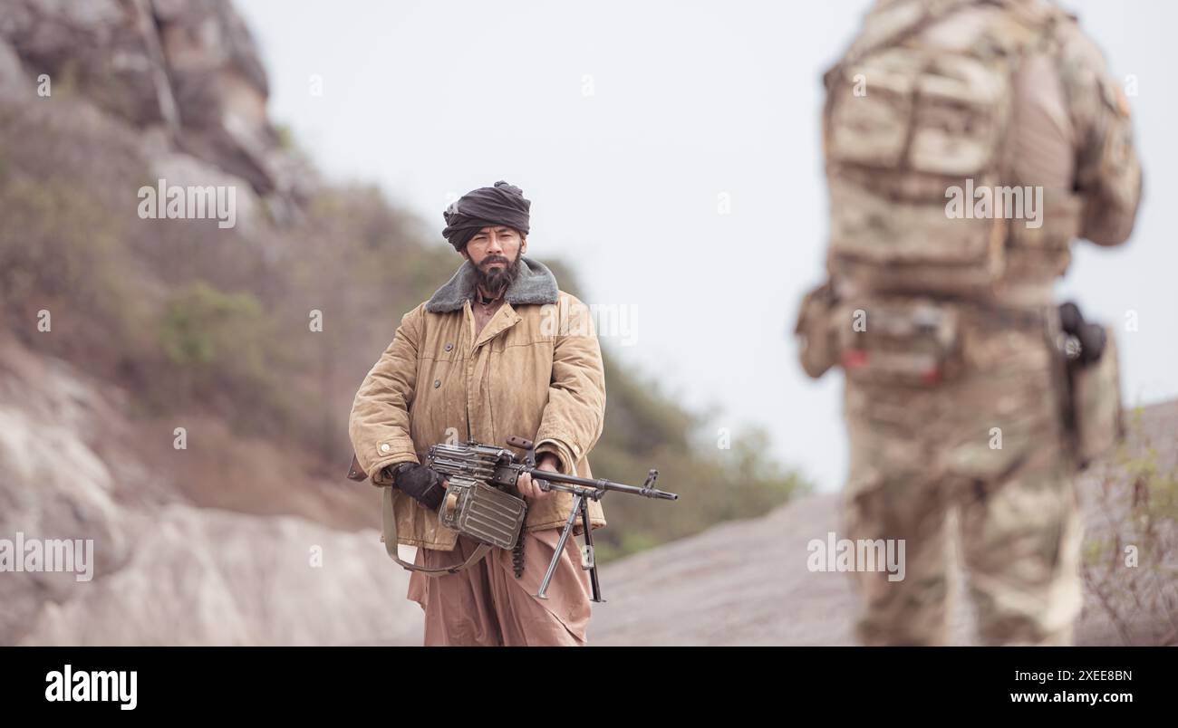 A Taliban soldier stands with a machine gun, Surrender to the allied ...