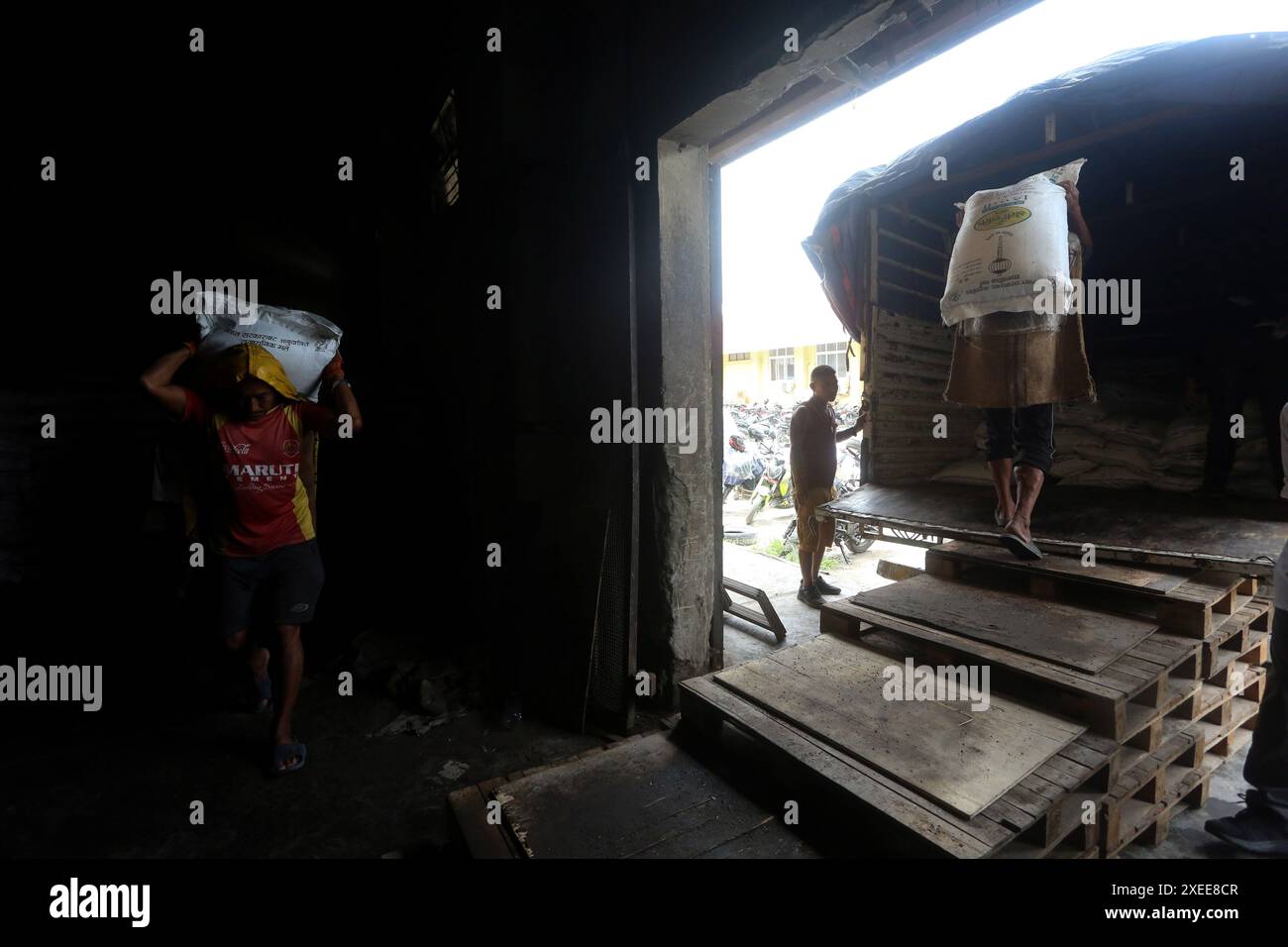 June 27, 2024: Workers carry sacks of chemical fertilizer for ...