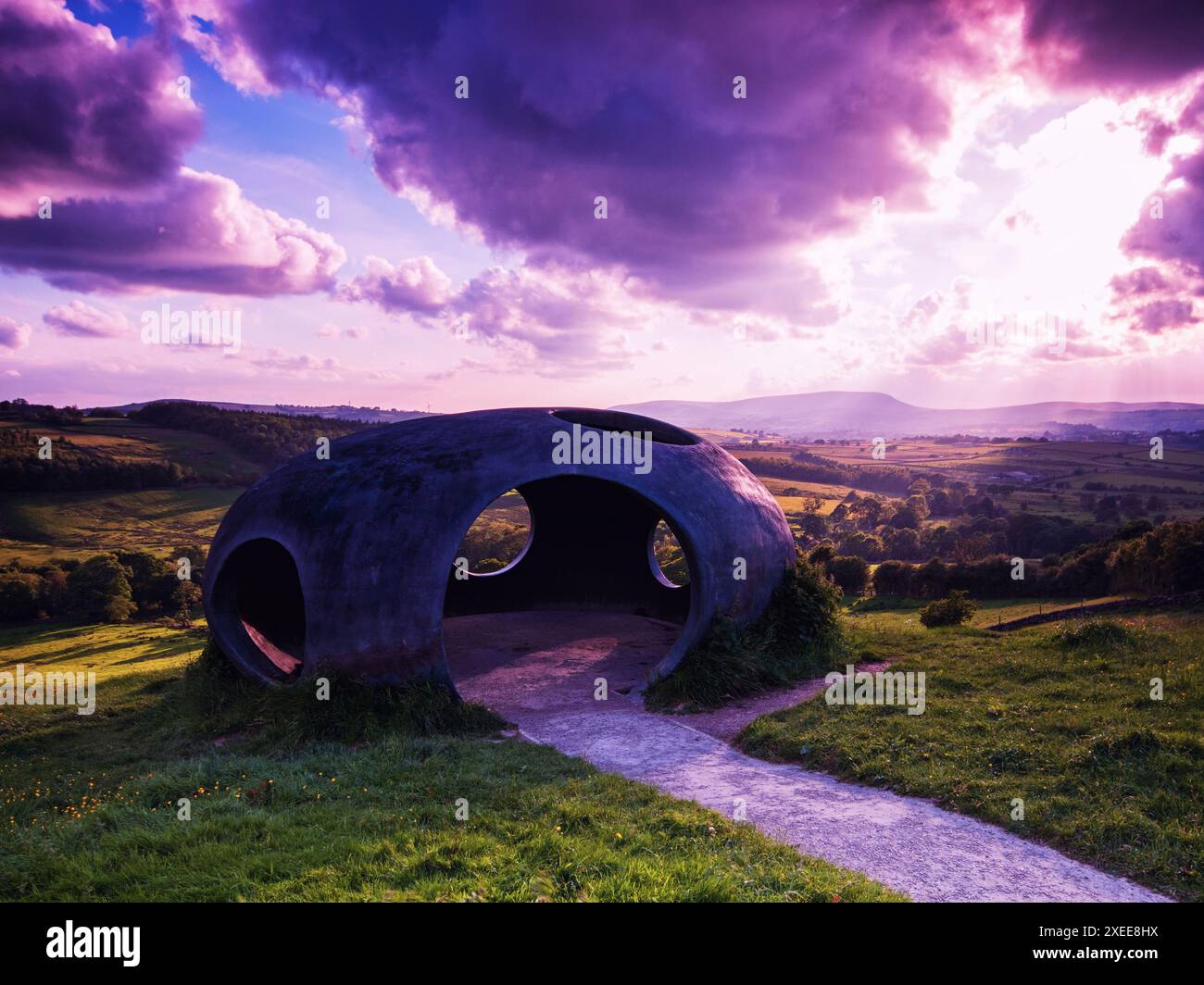 The Wycoller Atom below a dark cloud in dramatic backlight Stock Photo ...