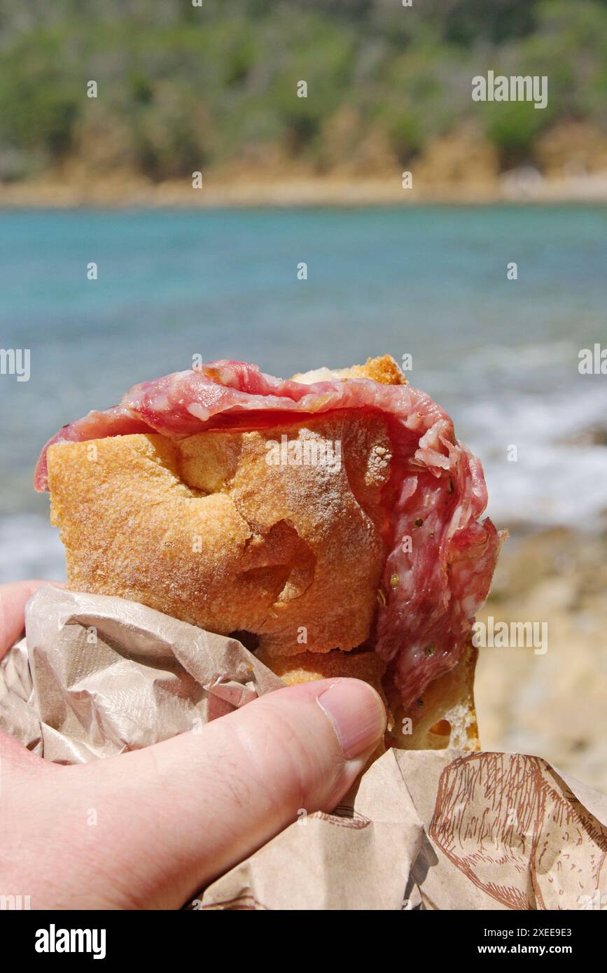 eating bread and salami sandwich on a beach Stock Photo - Alamy