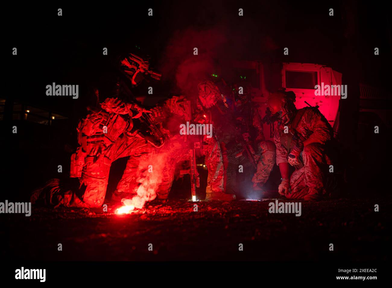 Group of soldiers in camouflage uniforms hold weapons with patrol ...