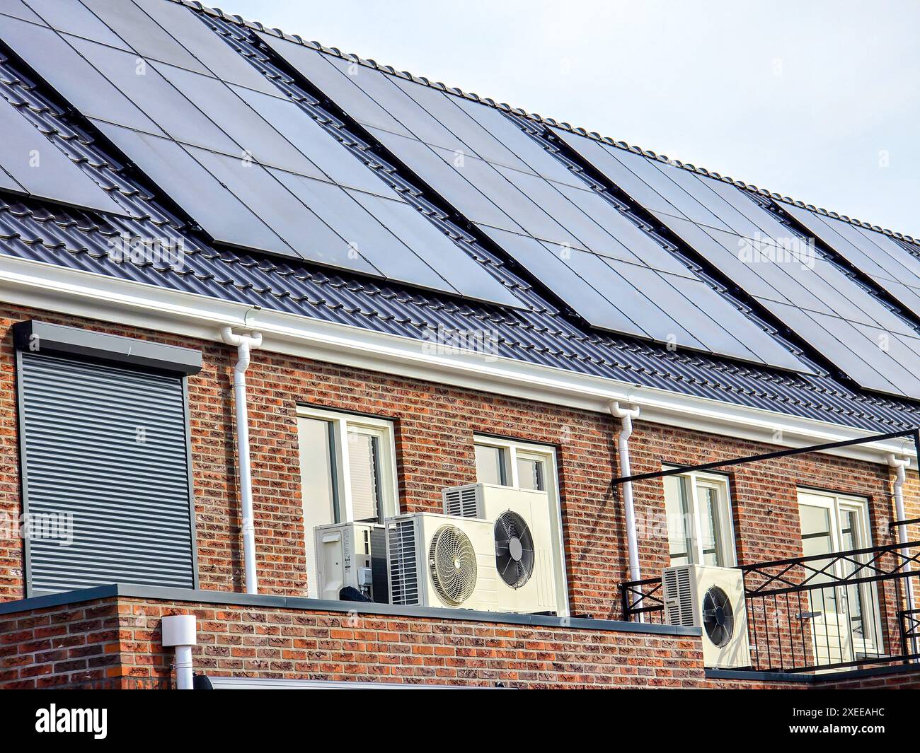 Air source heat pump unit installed outdoors at a modern home with ...