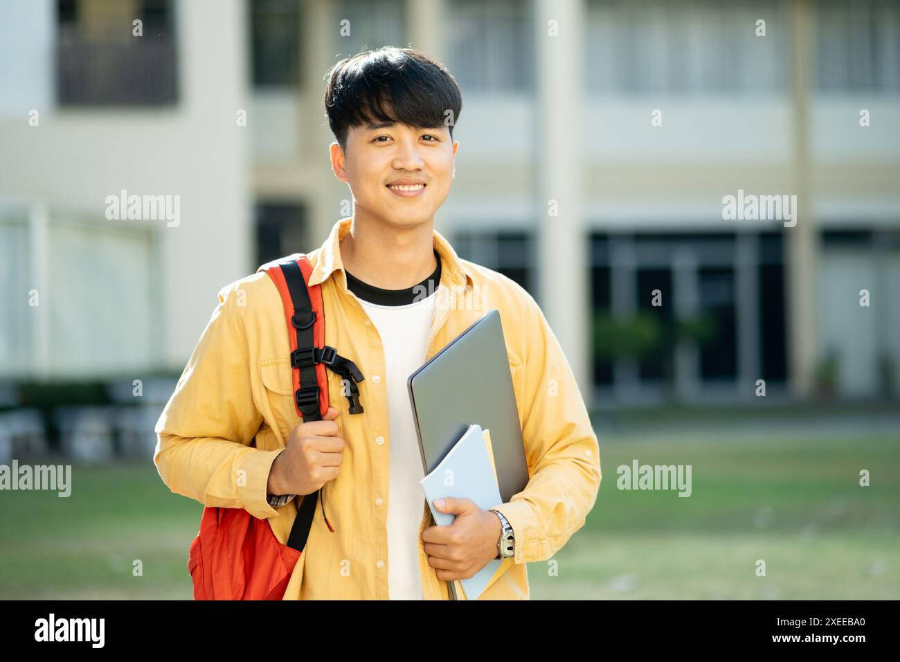 Smiling College Student with Laptop and Books on Campus Stock Photo - Alamy