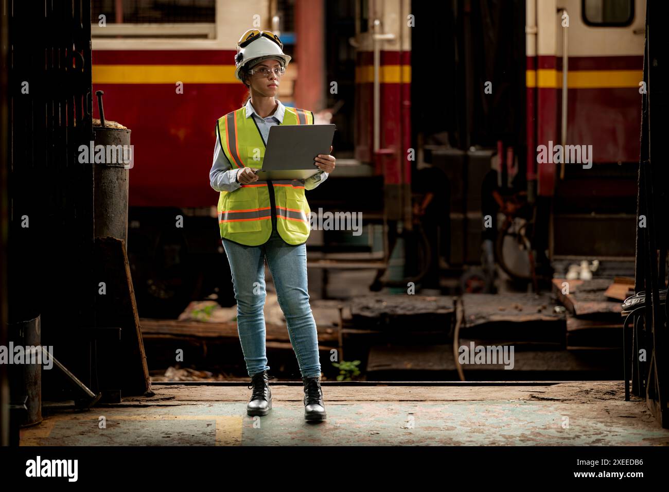 Portrait of railway technician worker in safety vest and helmet working ...