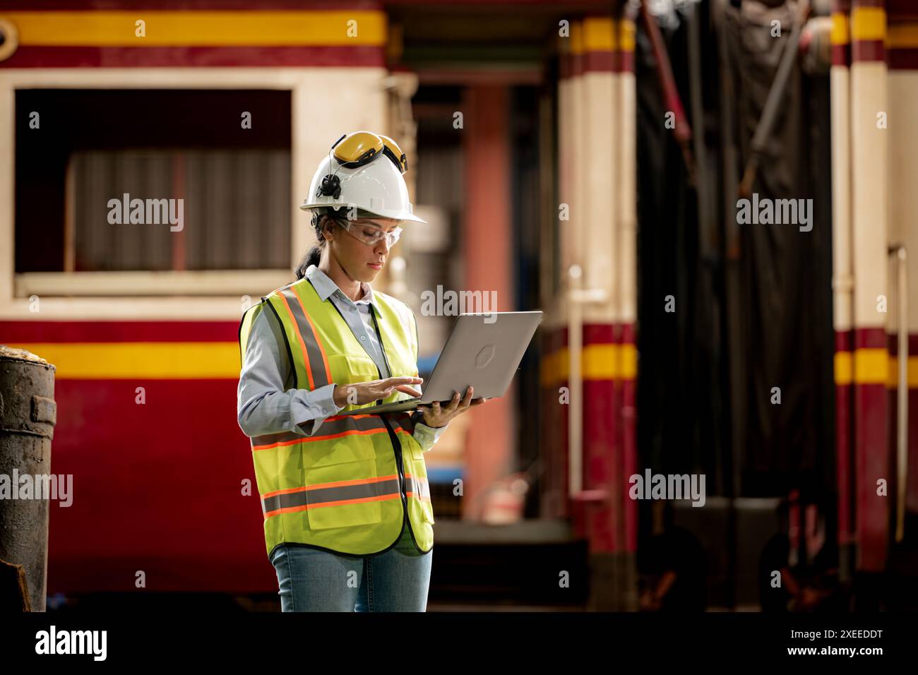 Portrait of railway technician worker in safety vest and helmet working ...
