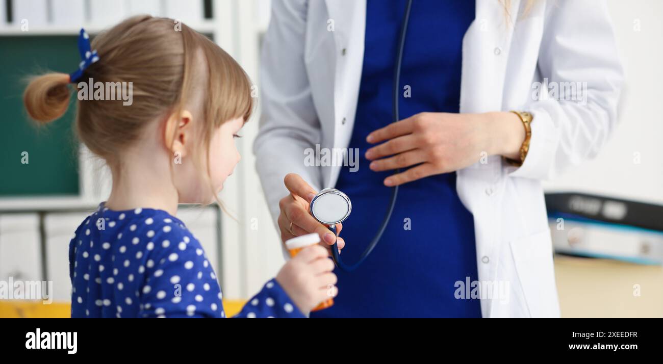Little child with stethoscope at doctor reception. Physical exam cute ...
