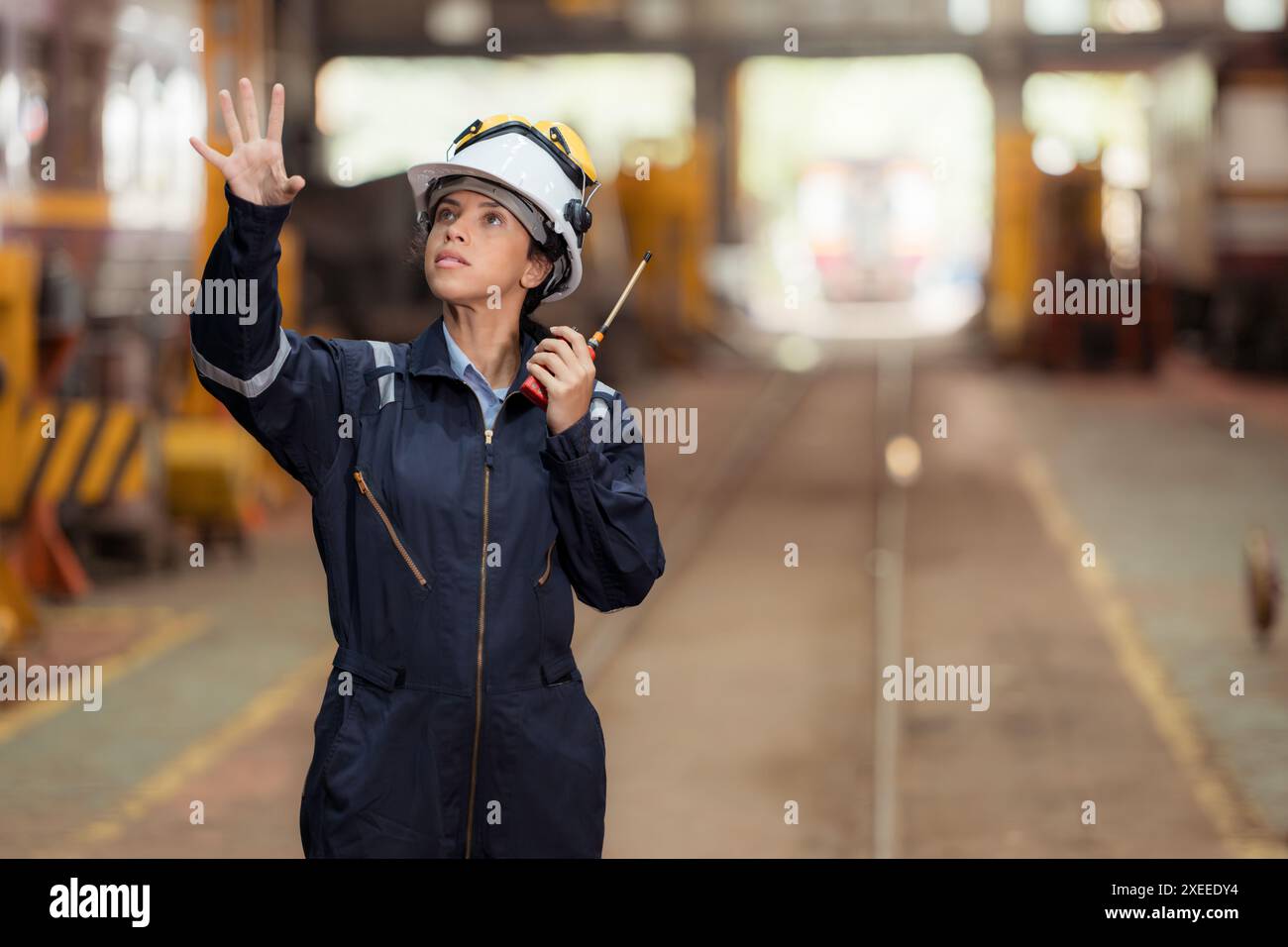 Portrait of railway technician worker in safety vest and helmet working ...