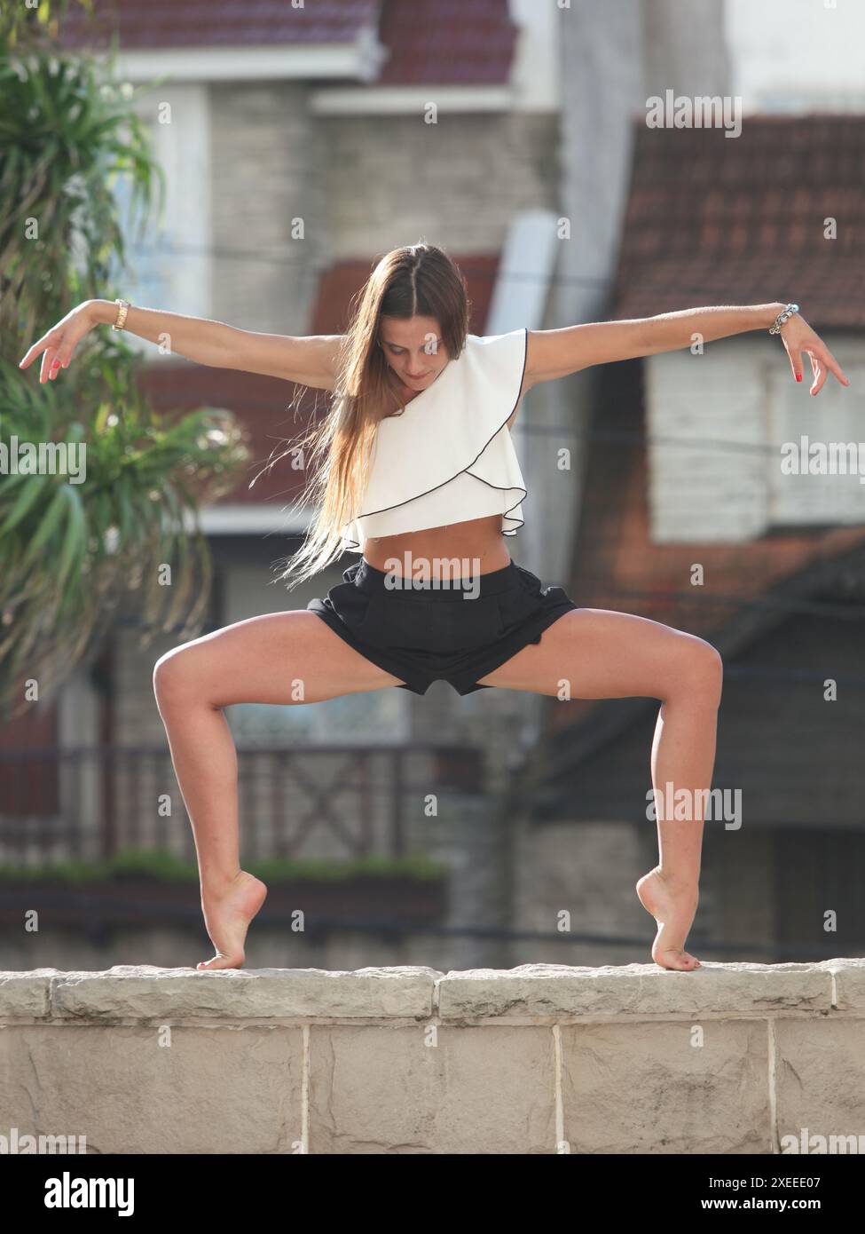 beautiful young woman doing dance movements outdoors Stock Photo - Alamy