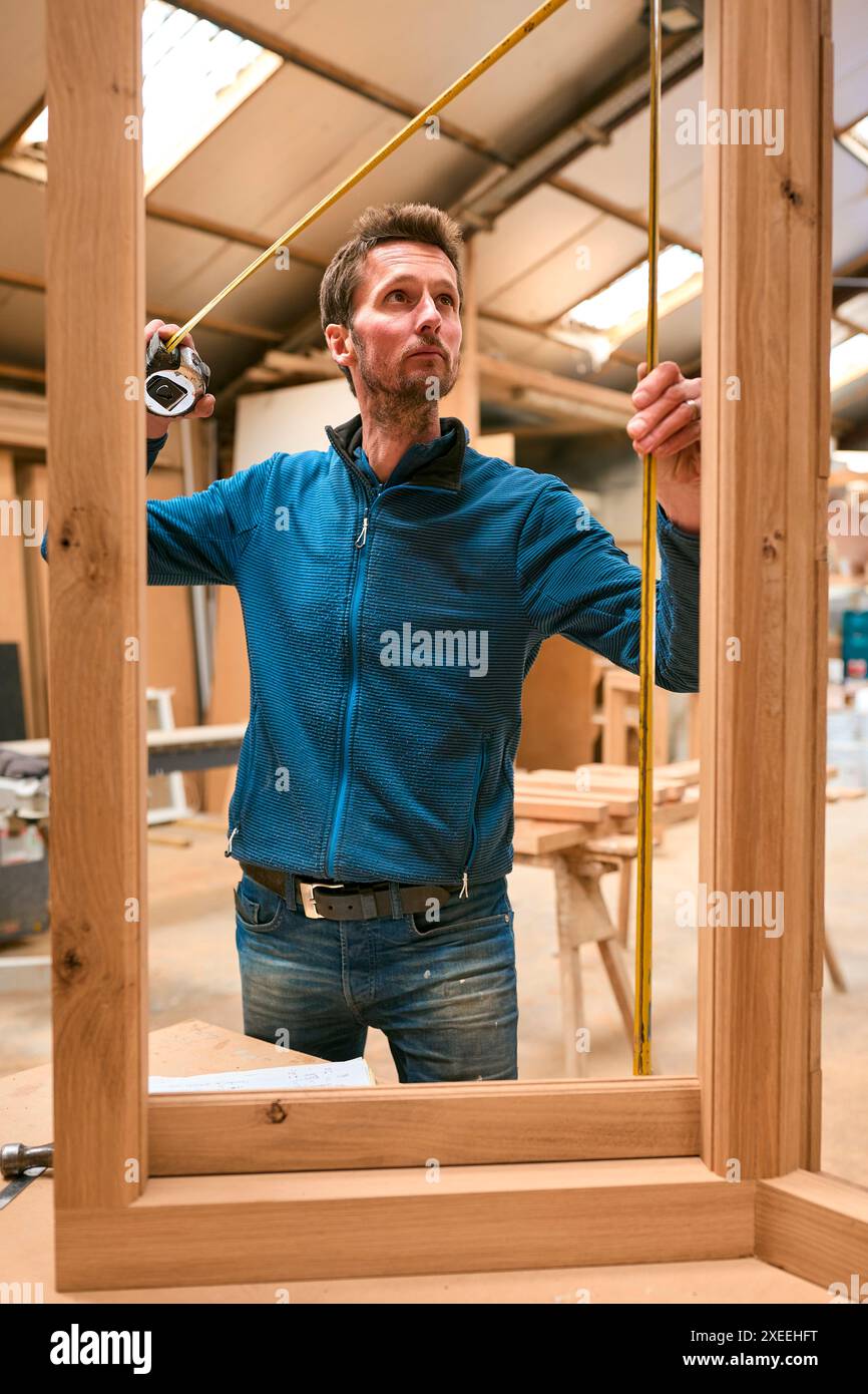 Carpenter In Workshop Measuring Wooden Window Frame Stock Photo - Alamy