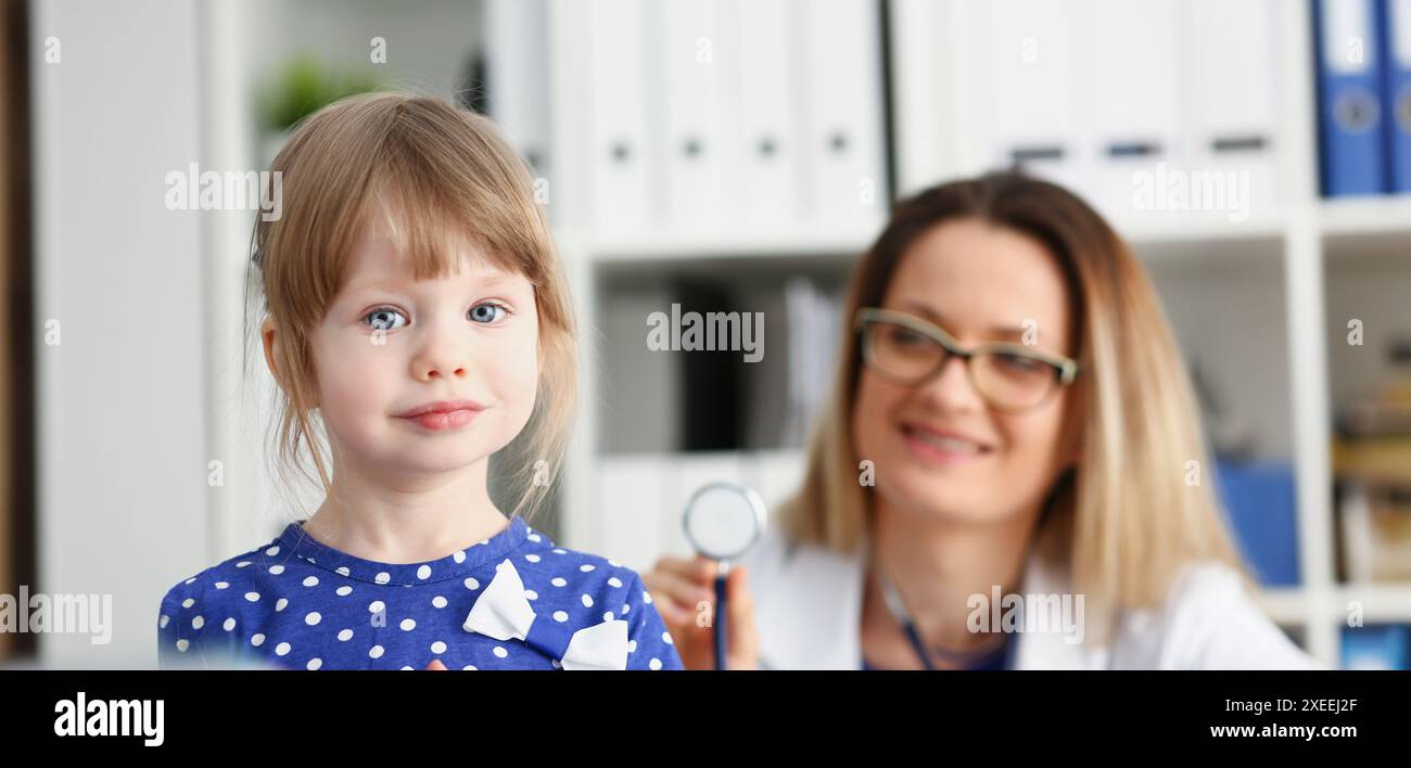 Little child with stethoscope at doctor reception. Physical exam cute ...