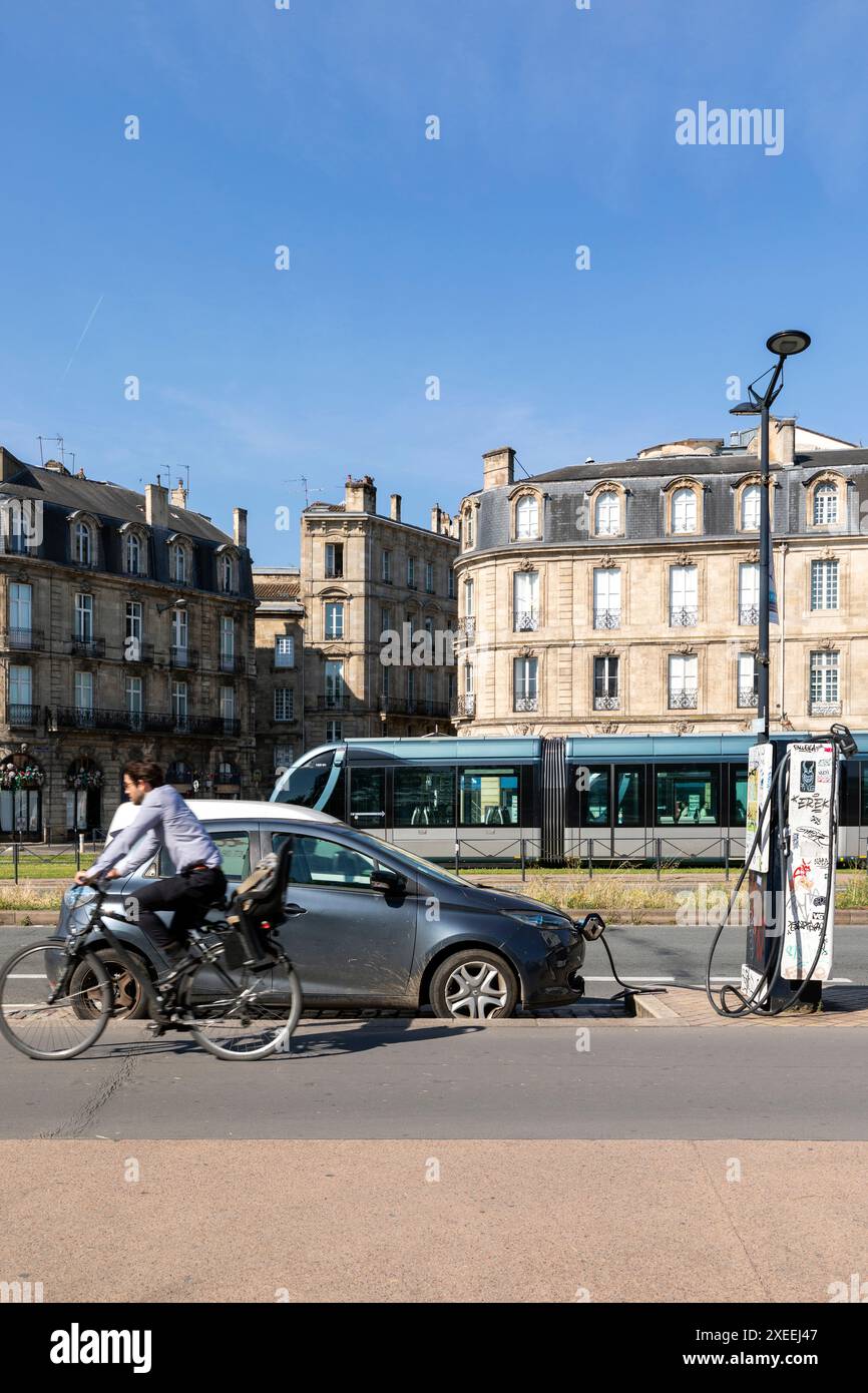 Electric Renault Zoé car plugged in a charging port in Bordeaux, with a ...