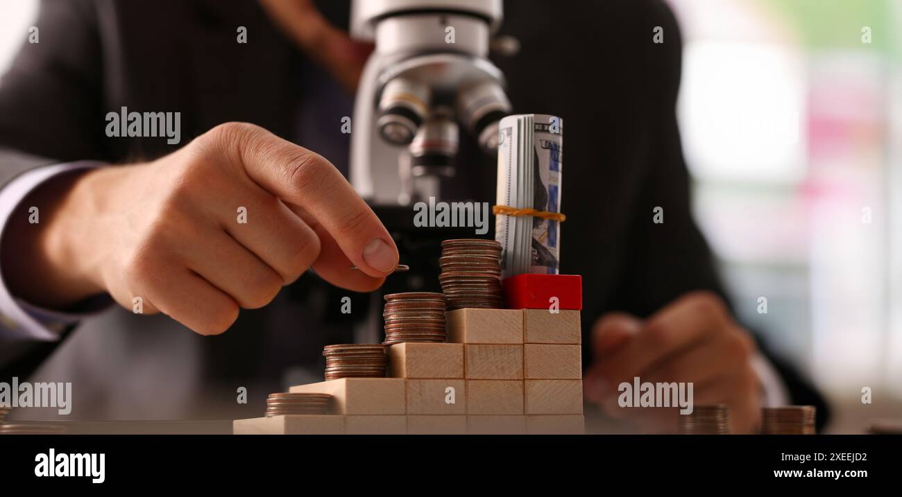 Hand businessman in suit hold quarter in background looking through ...