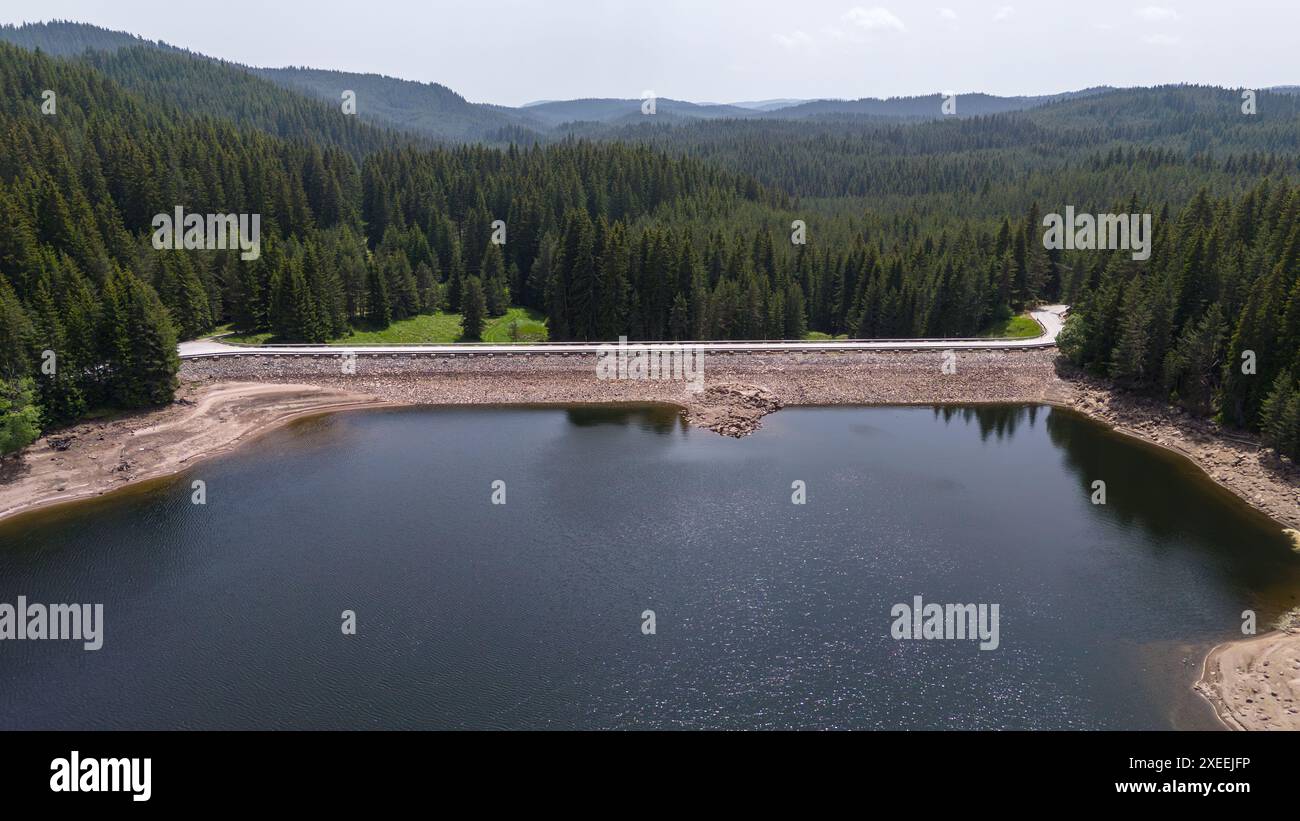 Aerial view of a dam wall, showcasing the contrast between the man-made ...