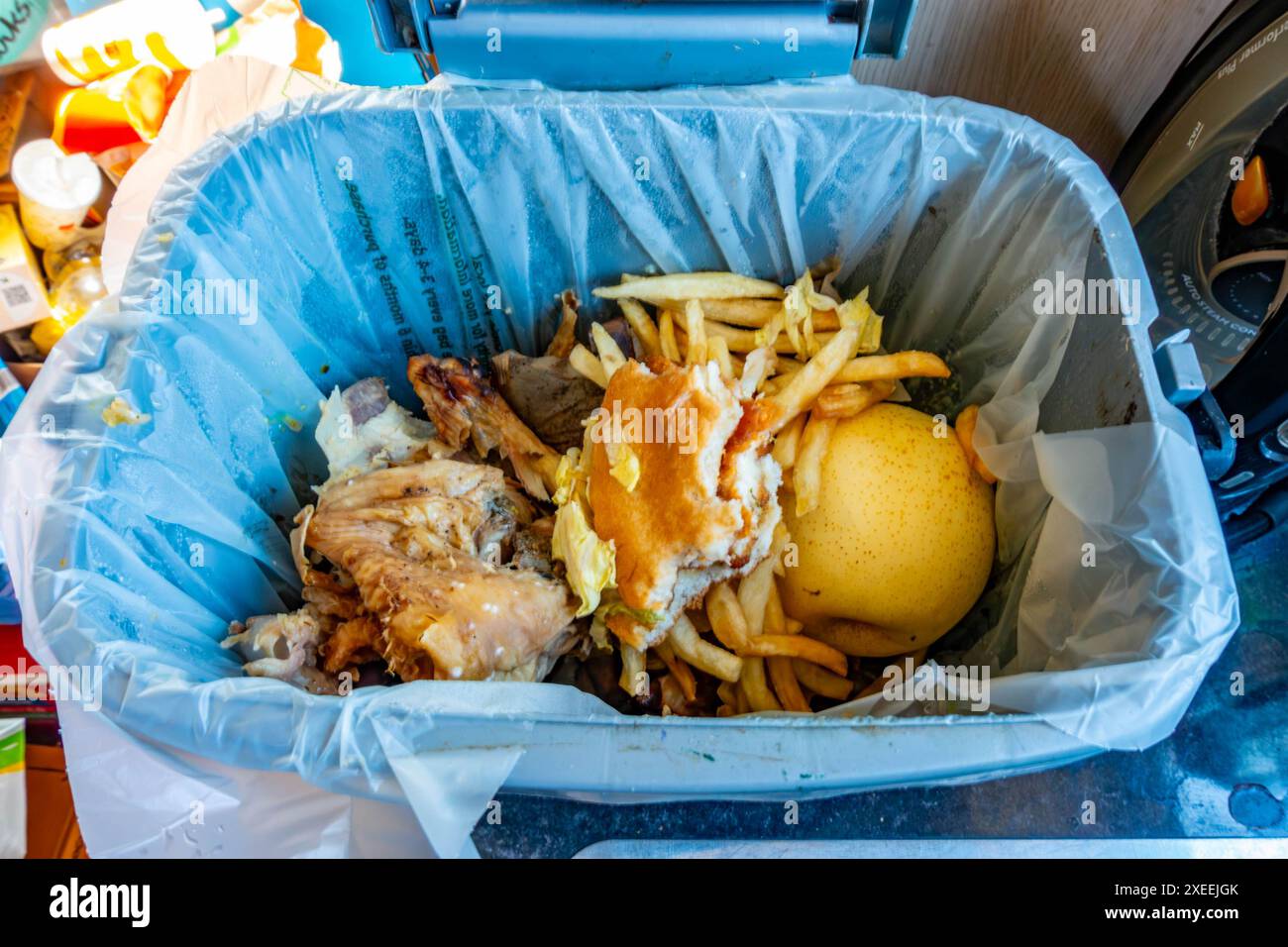 Leftover food waste in a kitchen worktop food caddy ready to be taken ...