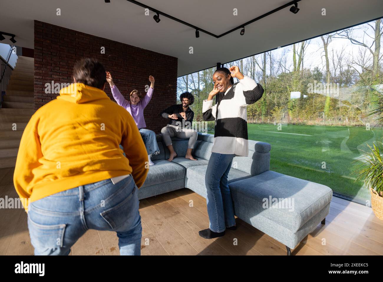 Joyful Friends Dancing Together in a Bright Modern Living Room Stock ...