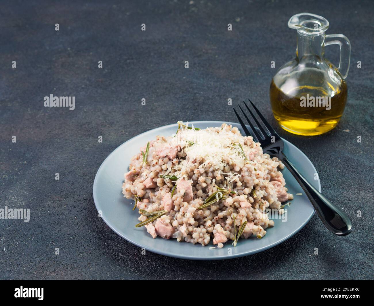 Raw buckwheat risotto with chicken meat and rosemary Stock Photo - Alamy