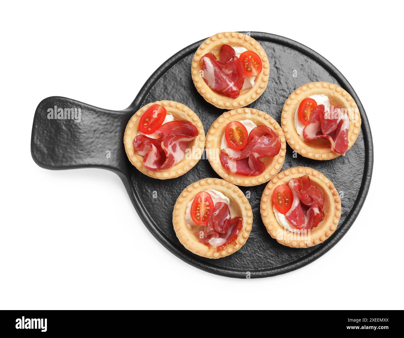 Delicious canapes with jamon, cream cheese and cherry tomatoes isolated ...