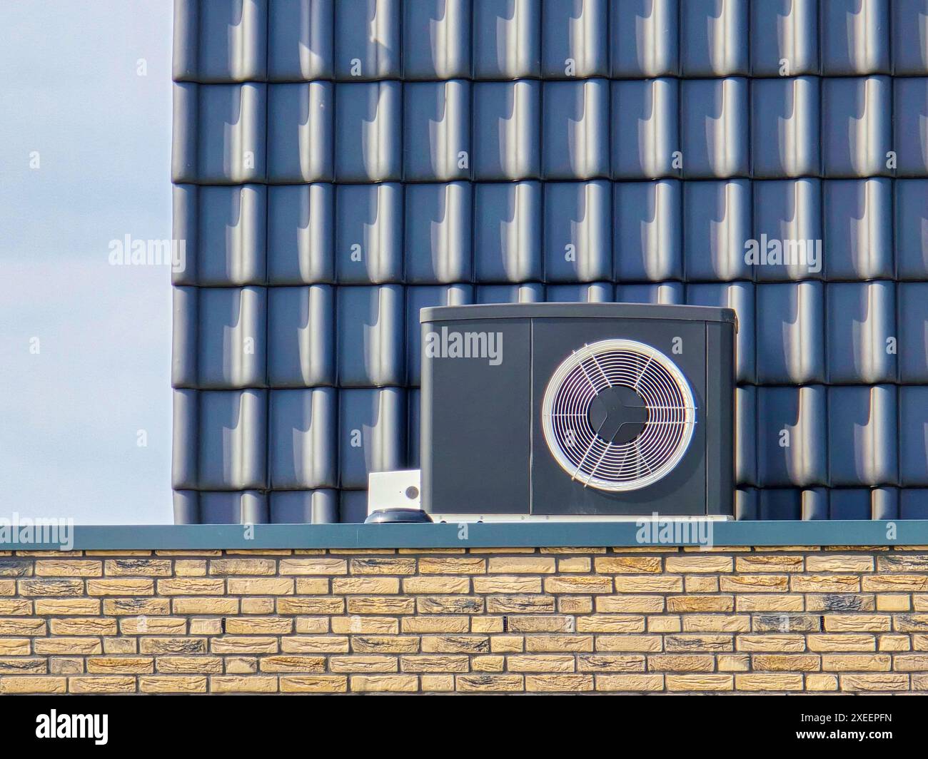 Air source heat pump unit installed outdoors at a modern home with ...