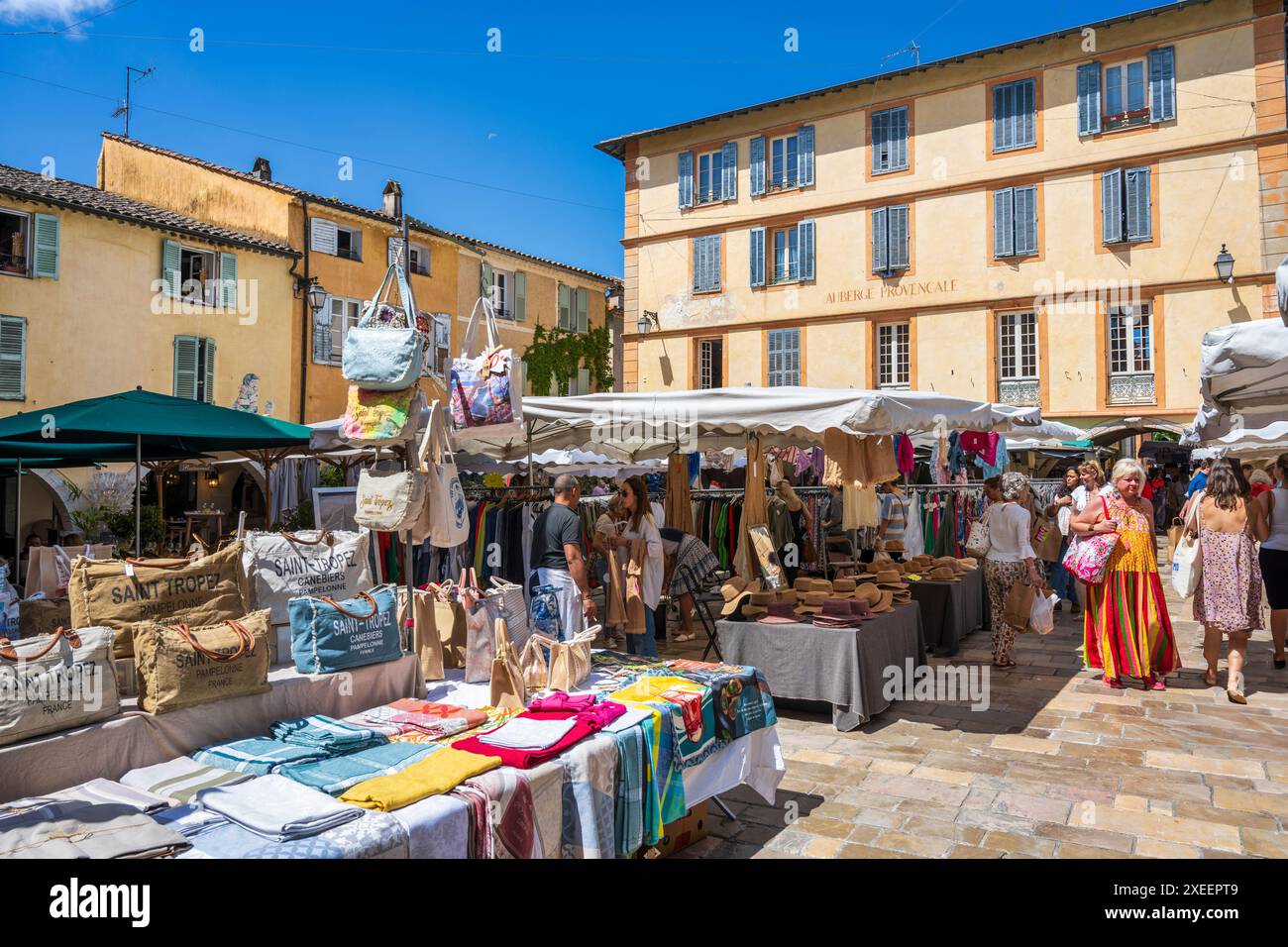 Market stalls in Place des Arcades on market day in the medieval ...