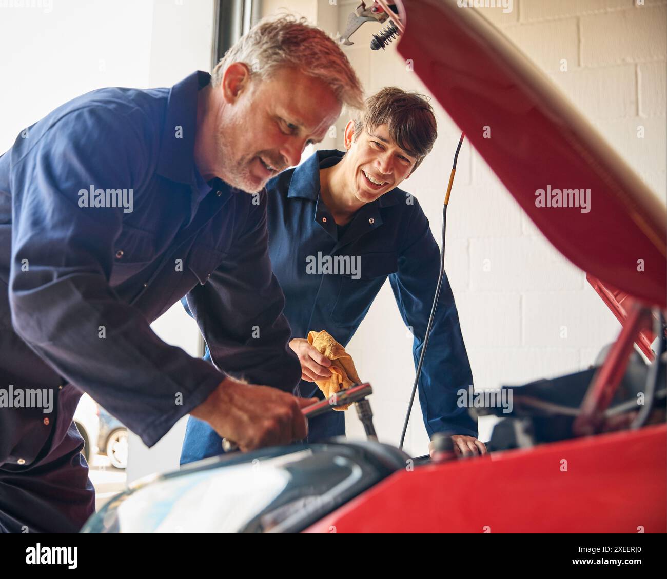 Car mechanic working under bonnet hi-res stock photography and images ...