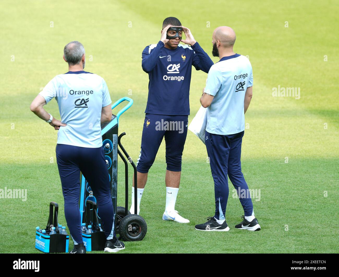 France's Kylian Mbappe puts on his protective mask during a training ...