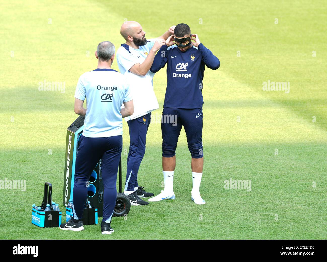 France's Kylian Mbappe puts on his protective mask during a training ...