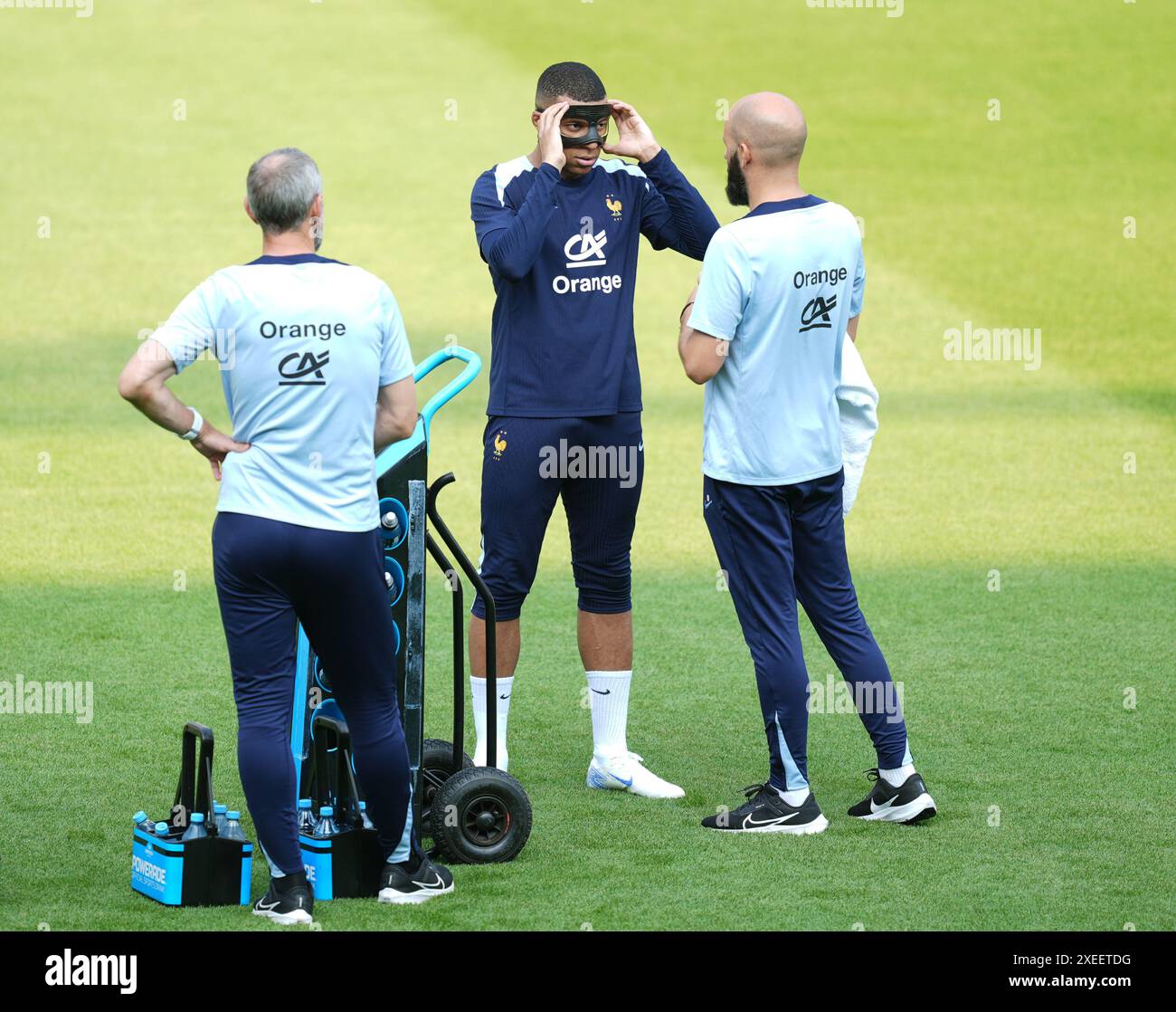 France's Kylian Mbappe puts on his protective mask during a training ...