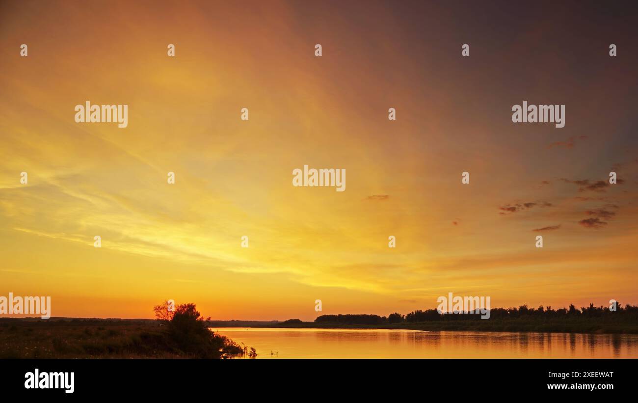 Sunset sky over river Stock Photo - Alamy