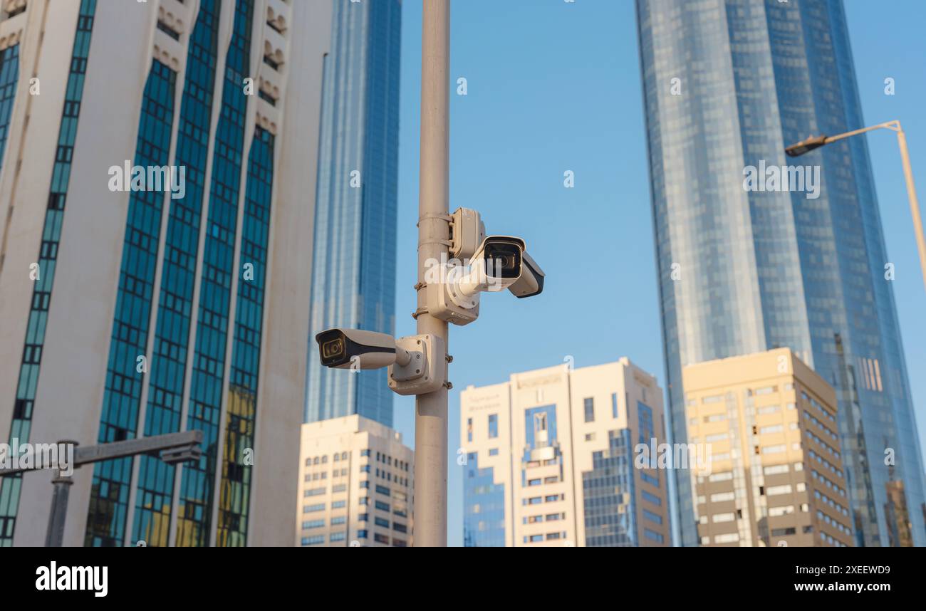 Digital modern cctv camera or security camera over blurred city skyline ...